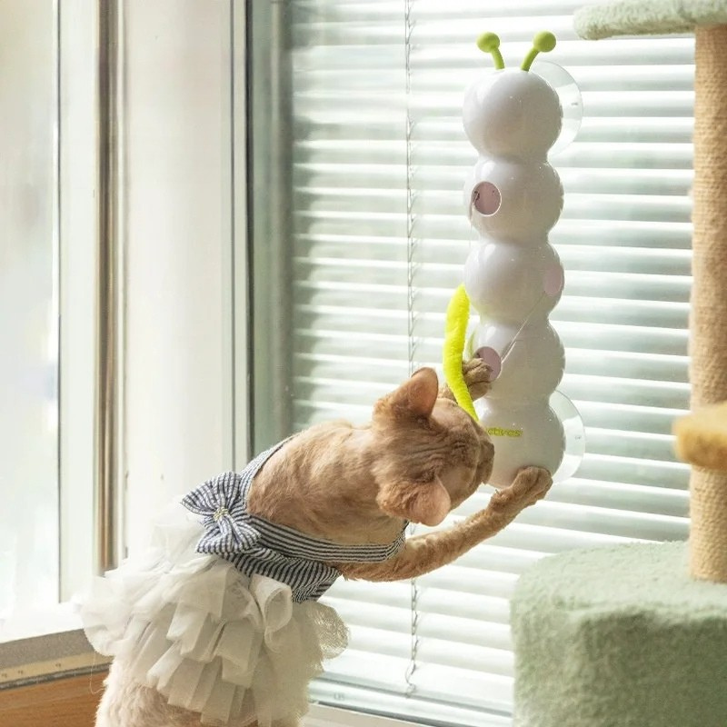 Interactive toy for cat shaped like a worm stick with automatic retrac ...